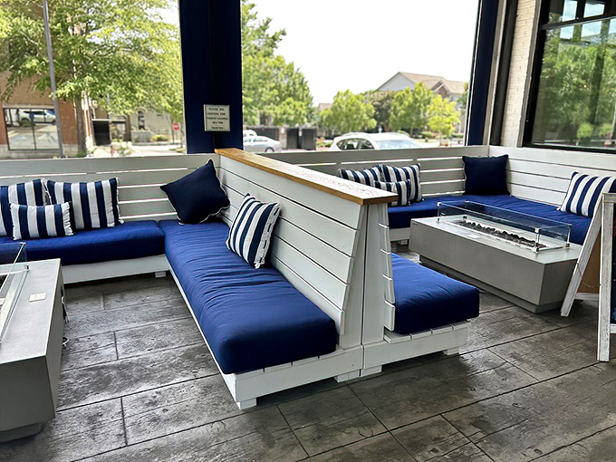 Outdoor seating that feels like a luxury yacht deck—navy cushions against white wood with fire features for those rare chilly Georgia evenings.