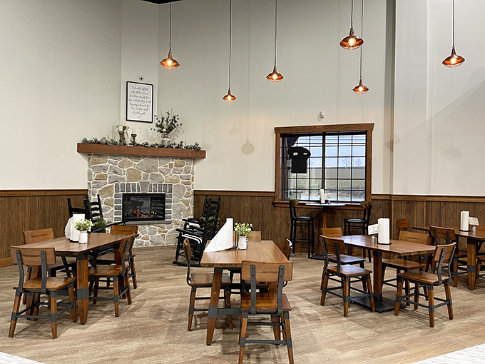A stone fireplace anchors the dining area, creating a gathering spot where strangers become neighbors over shared appreciation for exceptional food.
