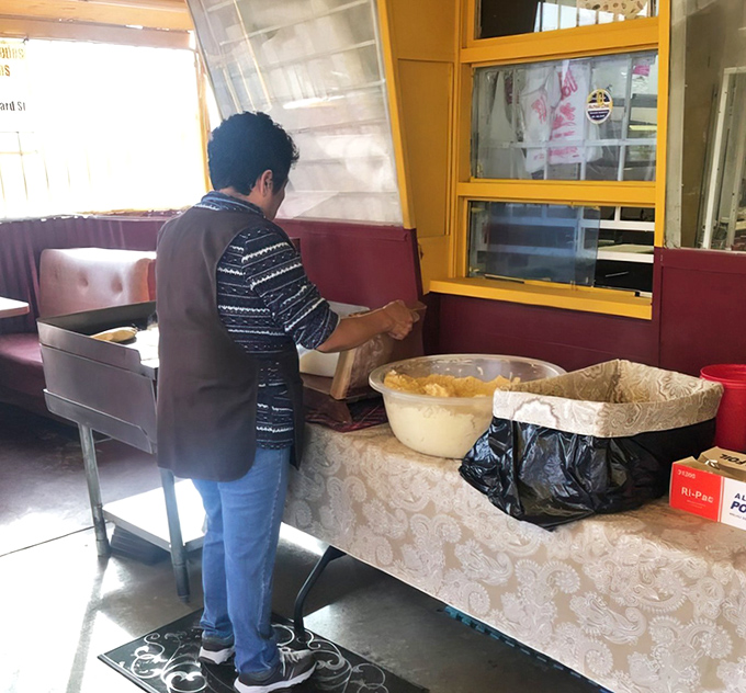 Witness the art of traditional tortilla-making in action. These aren't just ingredients being mixed; this is cultural heritage being preserved.