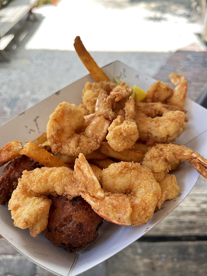 A basket of fried shrimp and hush puppies that would make Neptune himself weep with joy. That golden batter? Crispy perfection.