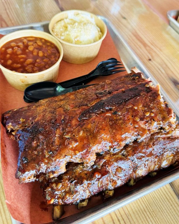 These ribs aren't just food&mdash;they're architecture. A glistening monument to patience, smoke, and the pursuit of perfection, with beans and potato salad as worthy companions.