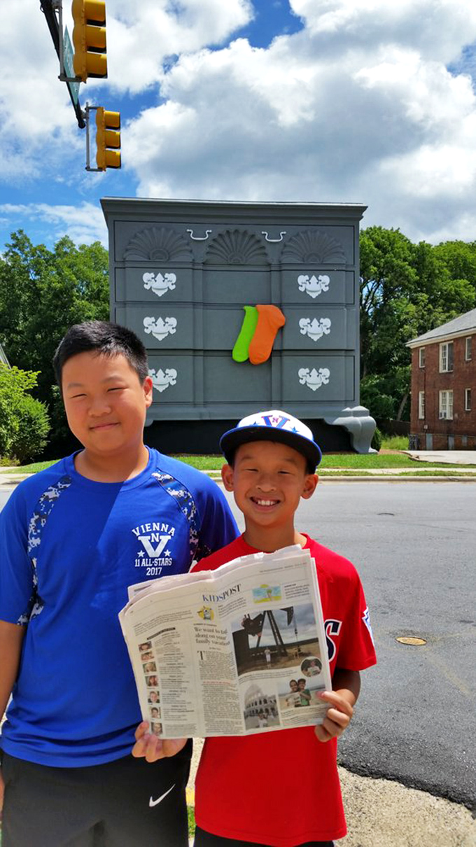These young newspaper readers prove that even in the digital age, nothing beats showing off your giant dresser discovery in print.