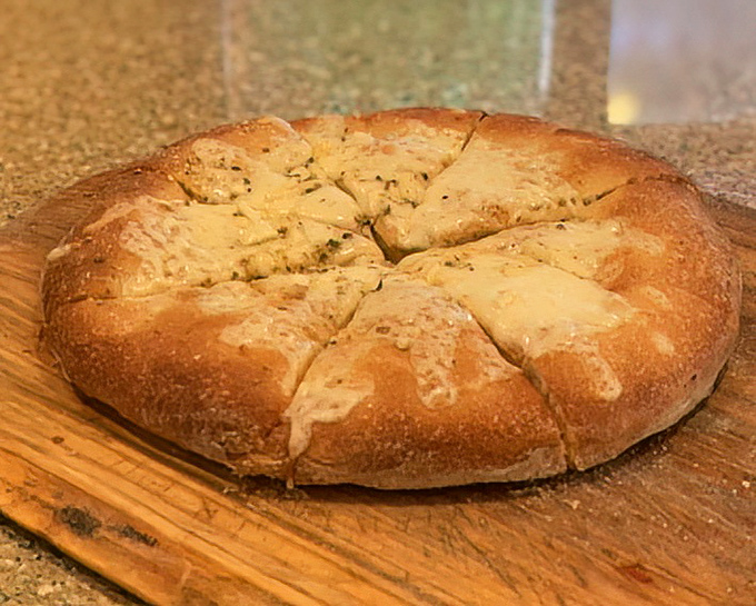 Garlic bread that's been working out &ndash; robust, golden, and ready to be torn apart. The perfect opening act to any pizza performance.