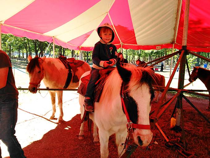 Childhood joy in its purest form &ndash; a first pony ride under a colorful tent creates memories that will last decades.