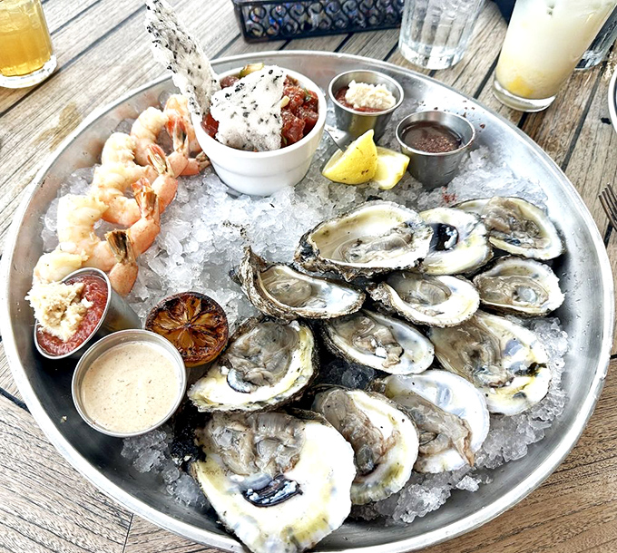 The seafood platter that makes decisions impossible. Oysters, shrimp, and more nestled on ice like jewels in a very delicious crown.