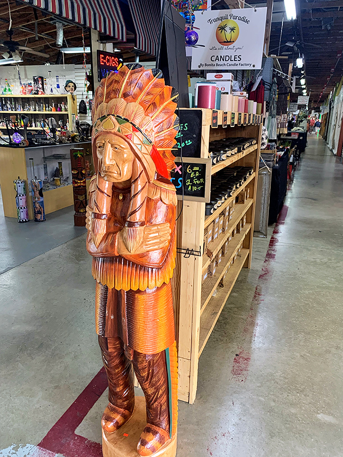 This wooden chief stands as a silent sentinel among the candles, a reminder of craftsmanship from an era before mass production.
