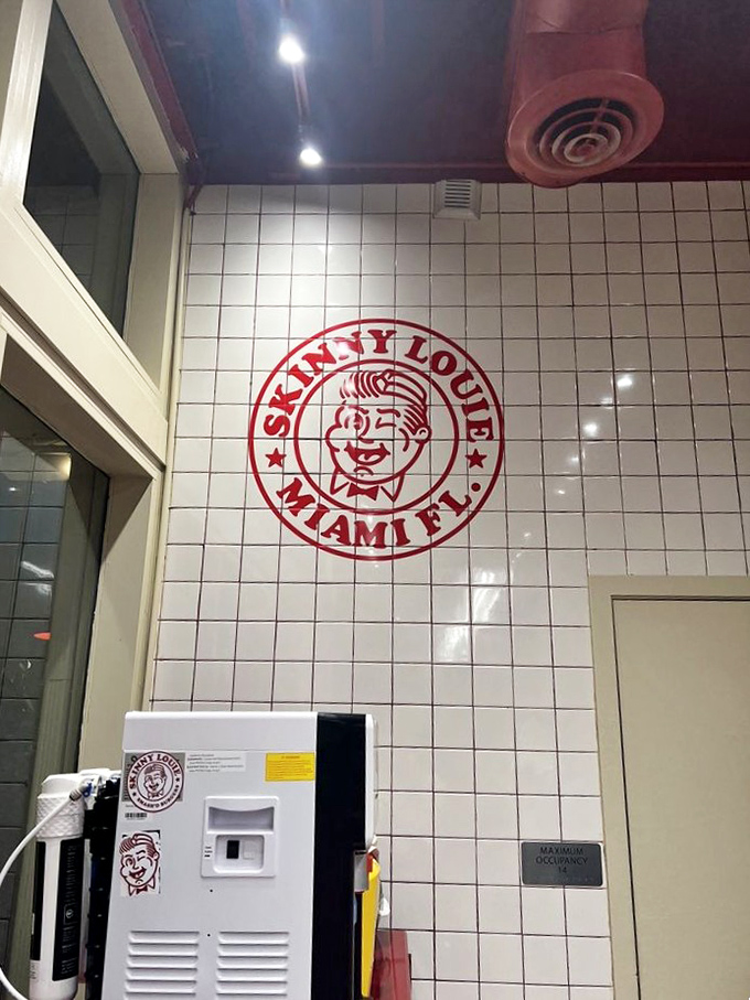 The iconic Skinny Louie logo watches over the proceedings like a benevolent burger deity ensuring quality in every bite.