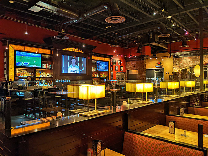 Warm lighting, rich woods, and strategically placed TVs create the rare space where sports fans and romantic diners peacefully coexist.