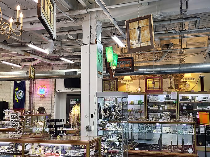 Vintage jewelry and curiosities gleam under display lights, each cabinet a treasure chest where someone's past becomes another's future heirloom.