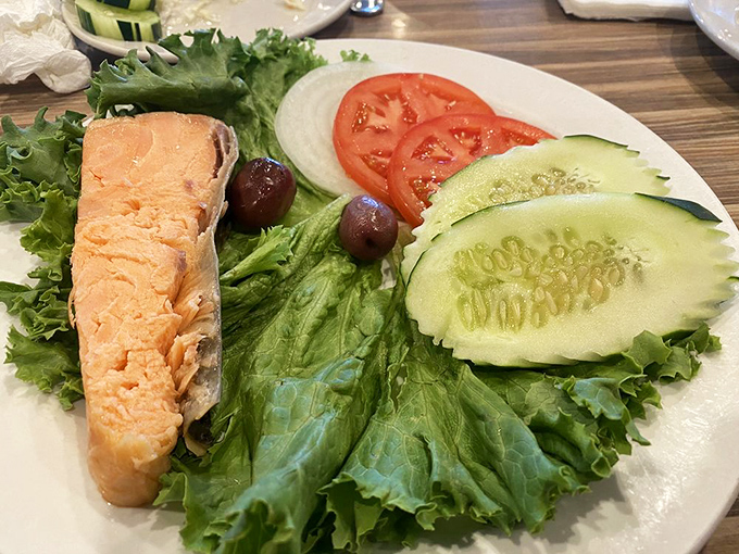 A salmon fillet lounging on a bed of crisp lettuce with cucumber, tomato and olives &ndash; the Mediterranean vacation your taste buds have been craving.