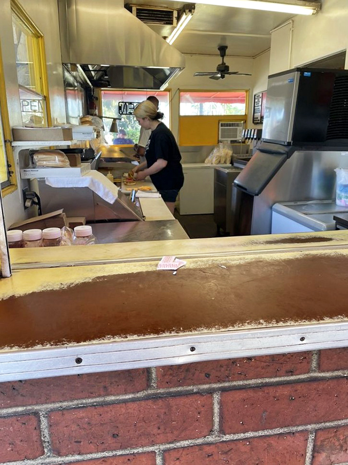 Behind the scenes magic happens in this compact kitchen, where decades of burger-flipping wisdom transforms simple ingredients into edible art.