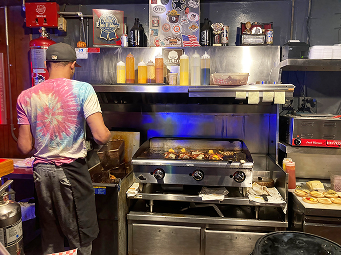The flat-top grill&mdash;seasoned by time and thousands of perfect sears. This isn't cooking equipment; it's a historical artifact that happens to make incredible burgers.