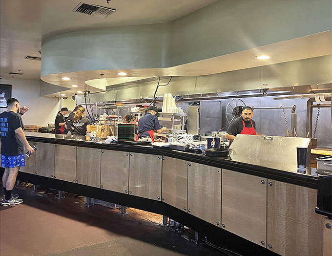 The open kitchen concept lets you witness the choreographed dance of burger artisans perfecting their delicious craft.