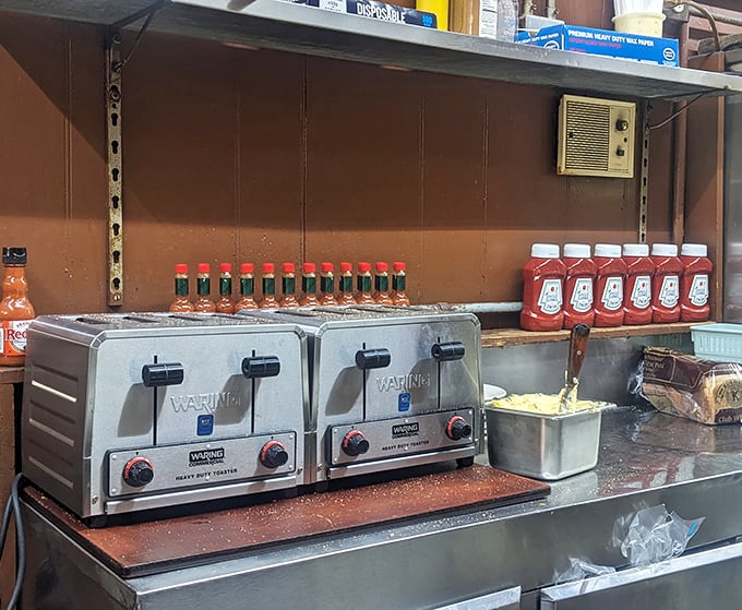 Tools of the trade. Those industrial toasters and perfectly aligned condiments represent the beautiful efficiency of a diner that knows exactly what it's doing.