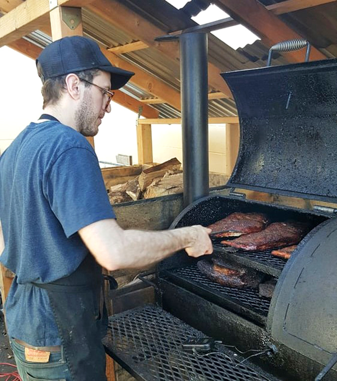 The pitmaster's dance – checking, turning, and feeling for that perfect moment when the meat has surrendered to time and smoke.
