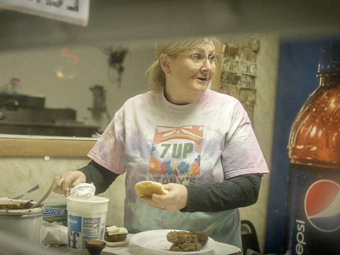 Behind every legendary burger is someone who knows exactly what they're doing. The pink 7UP shirt is the superhero cape of burger excellence. 