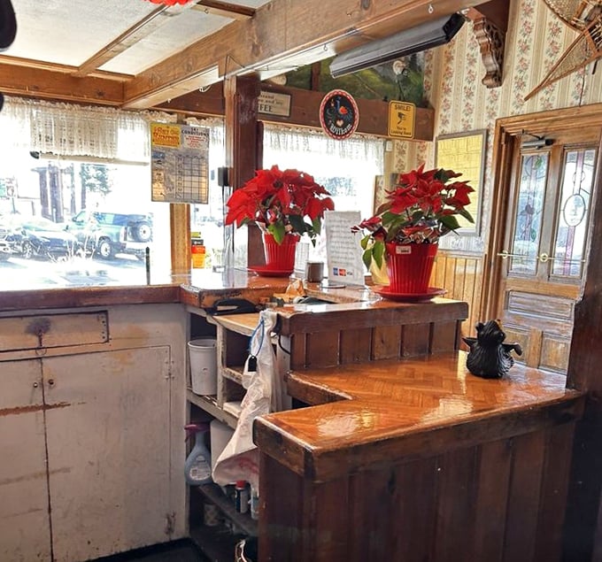 Holiday cheer meets breakfast headquarters. Poinsettias brighten the host station where countless hungry pilgrims have begun their pancake journeys.