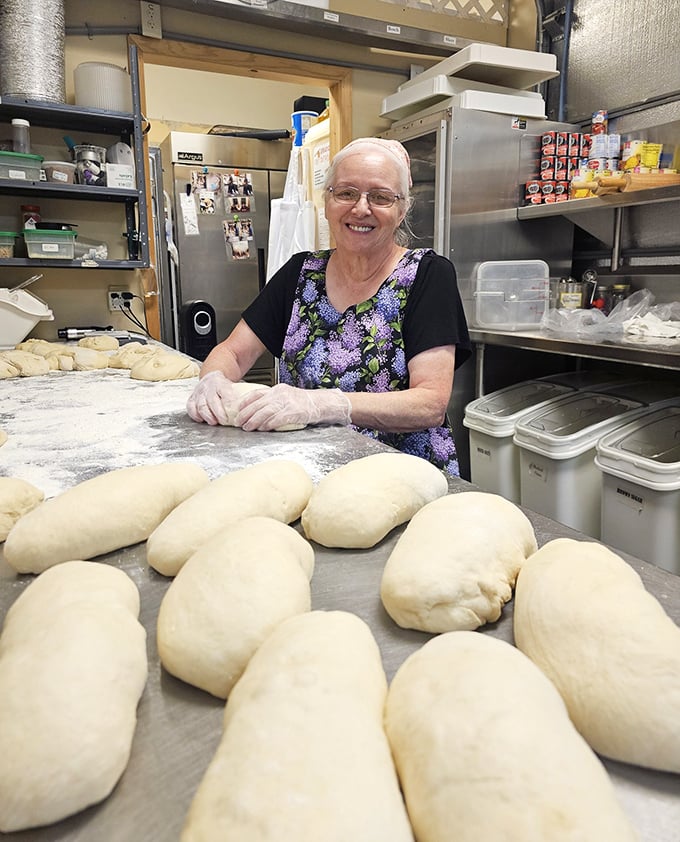 Hands that know dough like old friends. There's something magical about watching someone who's mastered their craft shape tomorrow's bread with such joy.