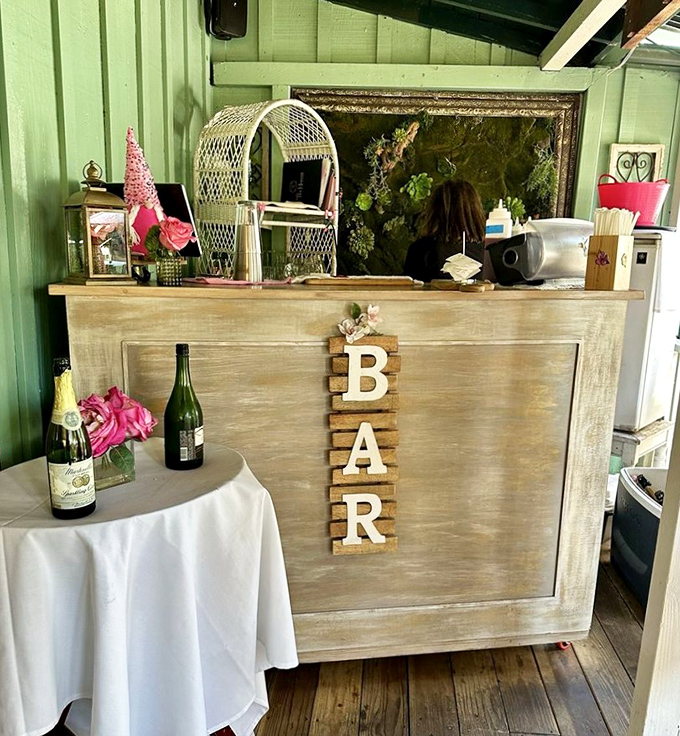 The bar area proves that champagne and tea can coexist beautifully. Wooden letters spelling "BAR" offer charming, unnecessary clarification.