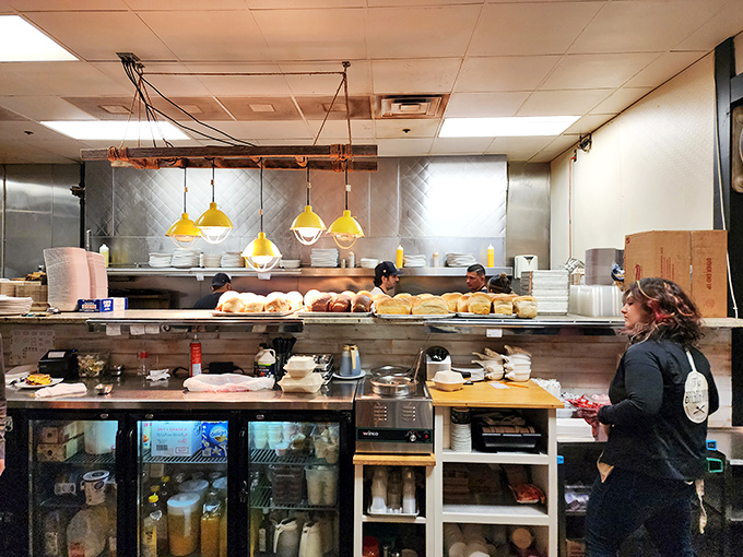 The open kitchen reveals the organized chaos behind breakfast perfection. Like watching breakfast ballet with better aromas.