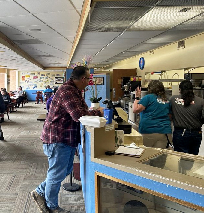 Where breakfast magic happens &ndash; the order counter stands ready, a blue-painted gateway to waffle nirvana and morning happiness.