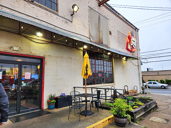 The outdoor seating area offers a front-row seat to Northeast Philly life, with the yellow umbrella adding a touch of sunshine even on cloudy days.