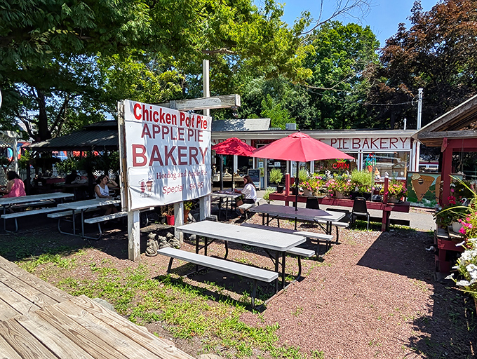 Outdoor seating where pie tastes even better with fresh air. The sign proudly announces their specialties like a town crier with delicious news.
