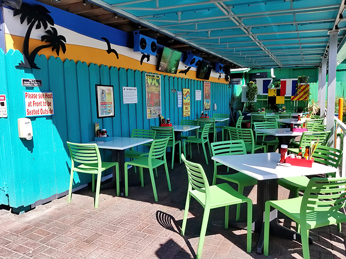 Al fresco dining, Florida-style. Turquoise walls and lime green chairs create an outdoor oasis where even the humidity feels like part of the charm.