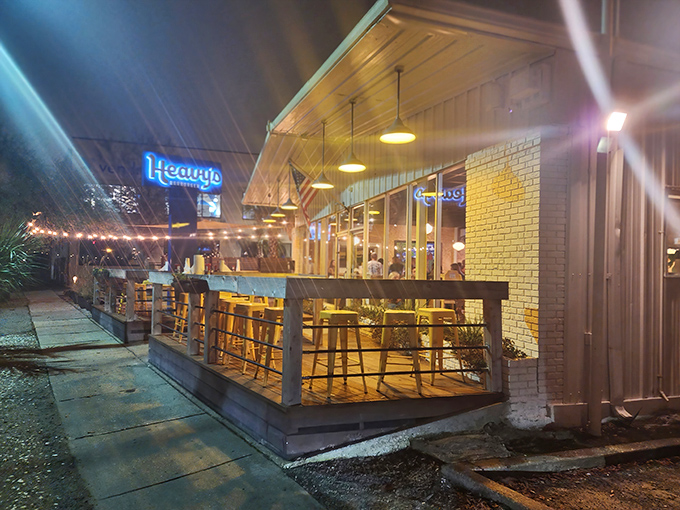 As night falls, Heavy's transforms into a glowing lantern of hospitality. Those yellow stools look even more inviting under the evening sky. 