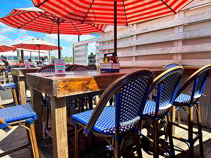 Red and white umbrellas stand guard over blue bistro chairs&mdash;a patriotic tribute to the serious business of relaxed dining.