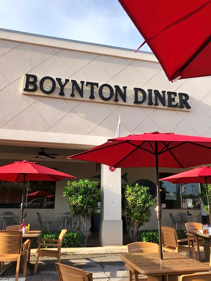 Red umbrellas offering shade for outdoor diners. Florida's version of al fresco dining&mdash;where breakfast meets sunshine.