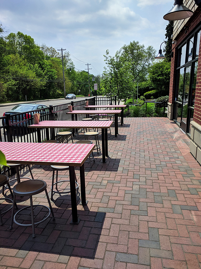 Al fresco chicken feasting with those signature red-checkered tables – because sometimes spice needs fresh air to be fully appreciated.