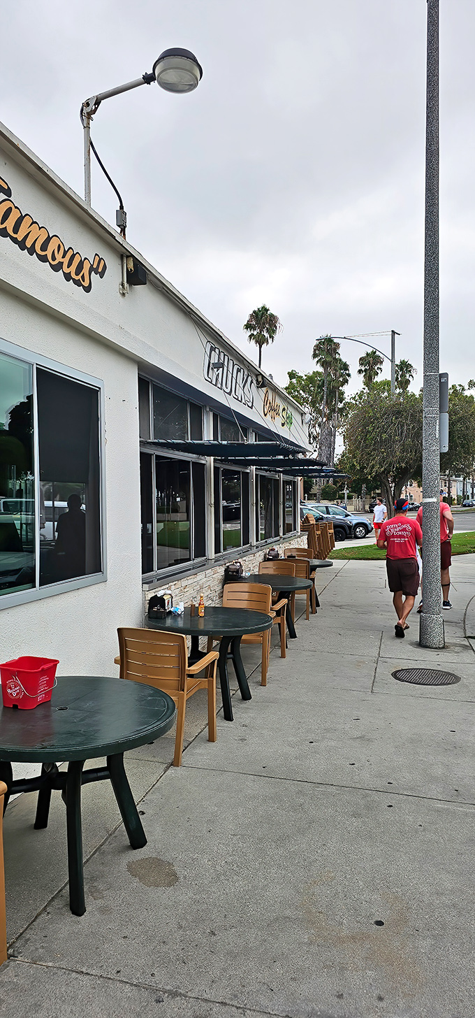 Sidewalk seating under California palms offers the quintessential Long Beach experience&mdash;ocean breezes with your burger and fries.