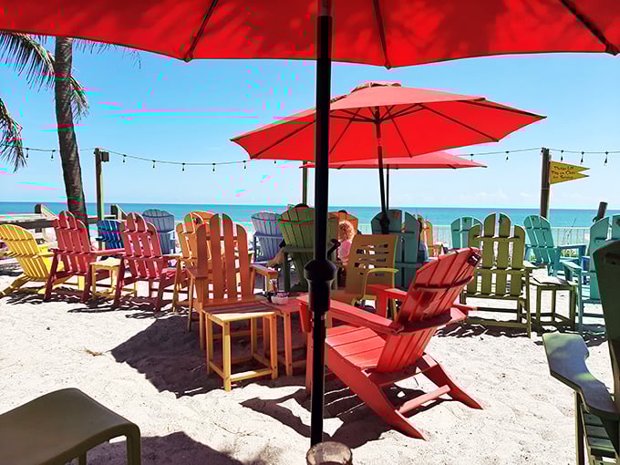 Beachfront dining at its most relaxed – where multi-colored chairs invite you to sink in, slow down, and remember why people move to Florida in the first place.