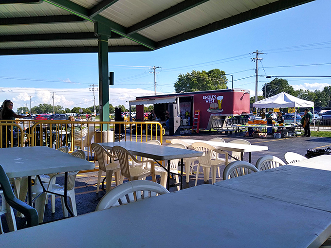 Outdoor seating under the green canopy creates the perfect pre-game atmosphere, where anticipation builds with every bite.