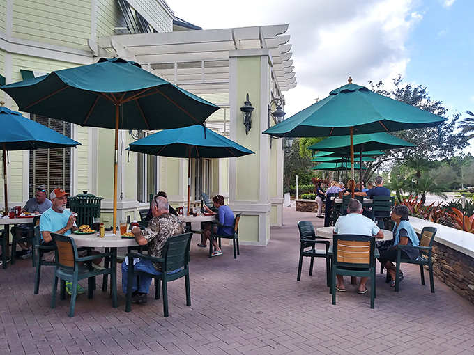 Teal umbrellas shield diners from Florida's enthusiastic sunshine while they enjoy the perfect outdoor meal. Al fresco dining as it was meant to be.