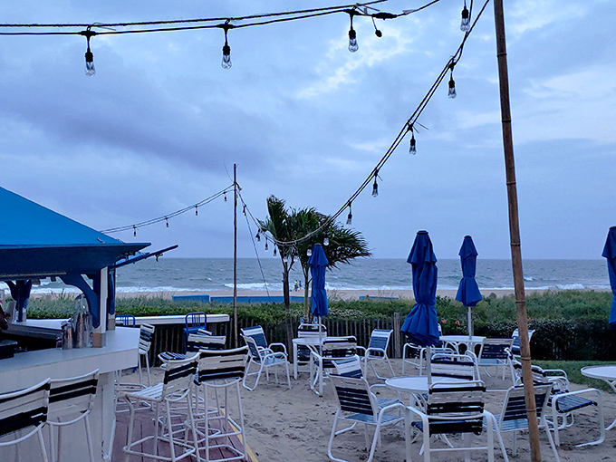 Ocean air mingles with string lights at this beachside sanctuary, where the soundtrack of waves provides the perfect background music for vacation memories.