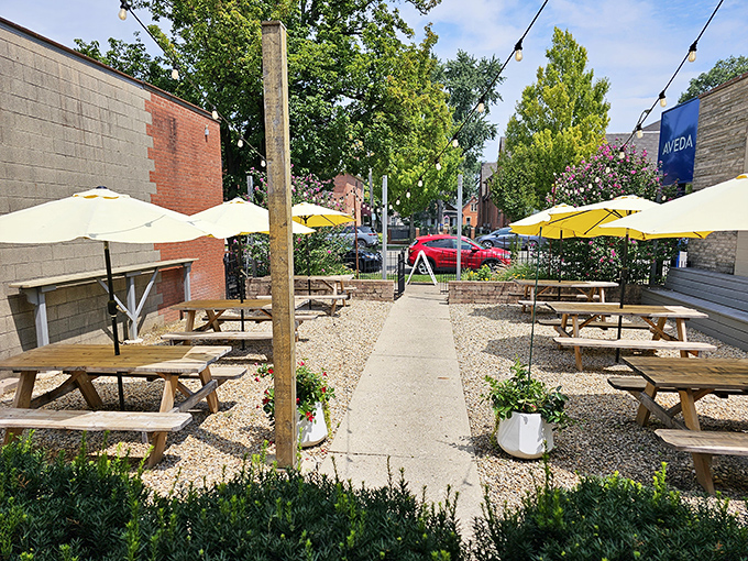 Outdoor dining that feels like the best backyard party in town. Those yellow umbrellas are beacons for barbecue pilgrims.