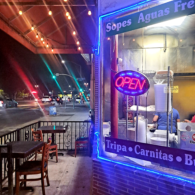 As night falls, the neon "OPEN" sign becomes a beacon for taco pilgrims seeking authentic flavors.