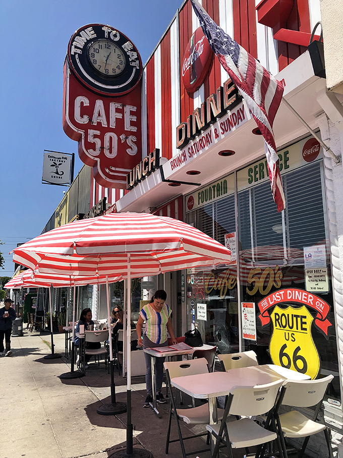 Sidewalk seating under candy-striped umbrellas. The "Last Diner on Route 66" sign reminds you that some traditions are worth preserving in the California sun.