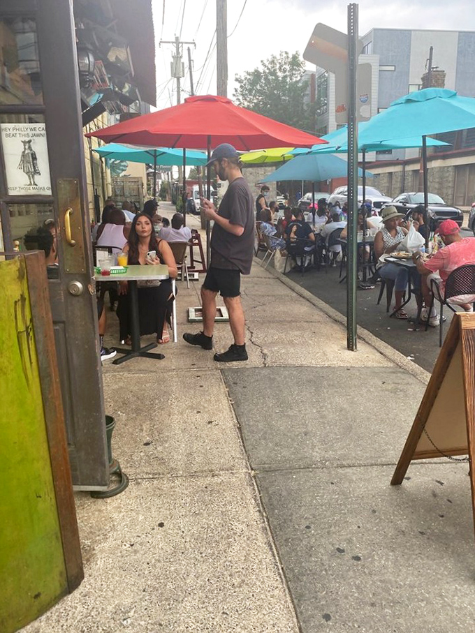 Outdoor seating under colorful umbrellas transforms a Philadelphia sidewalk into the perfect spot for people-watching between bites of breakfast bliss.