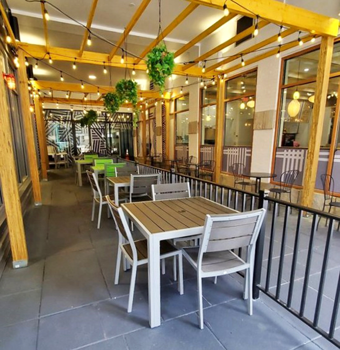 The outdoor patio at BurgerFi feels like a secret garden for burger lovers. String lights overhead turn a simple meal into an al fresco celebration.