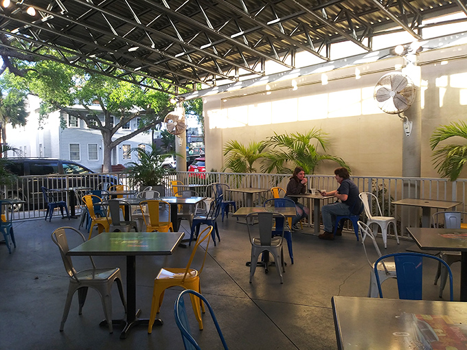 The outdoor seating area offers a shaded escape with colorful chairs&mdash;perfect for enjoying your burger while people-watching in downtown Melbourne. 
