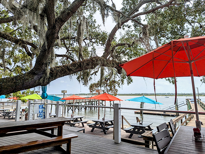Spanish moss drapes the live oaks like nature's party decorations, creating the perfect canopy for an afternoon of riverside dining.