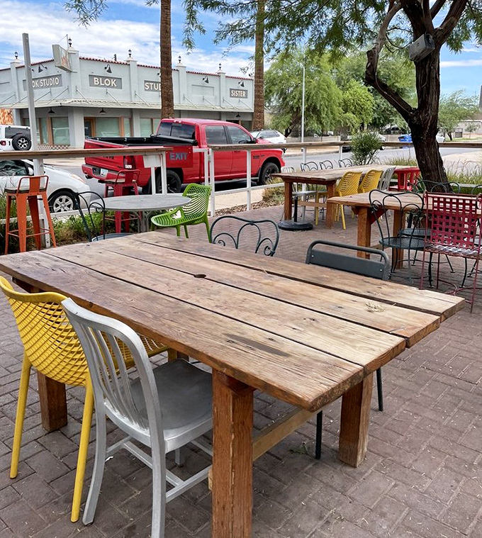 Mismatched chairs in cheerful colors surround rustic wooden tables &ndash; outdoor dining with the casual charm of your coolest friend's backyard party.