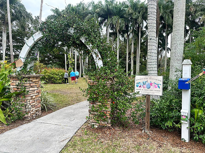 Palma Sola Botanical Park's entrance archway serves as a portal between everyday Florida and a meticulously curated tropical wonderland.