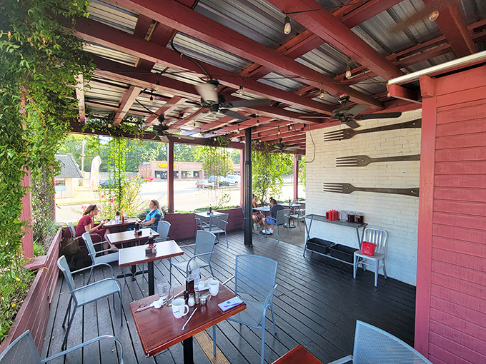 Outdoor seating where the forks on the wall aren't just decoration&mdash;they're signaling to passersby that serious eating happens here.