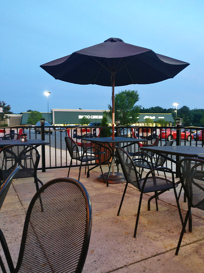 As twilight settles, the patio becomes an oasis. Metal chairs, umbrellas, and the promise of a meal under Maryland's evening sky.