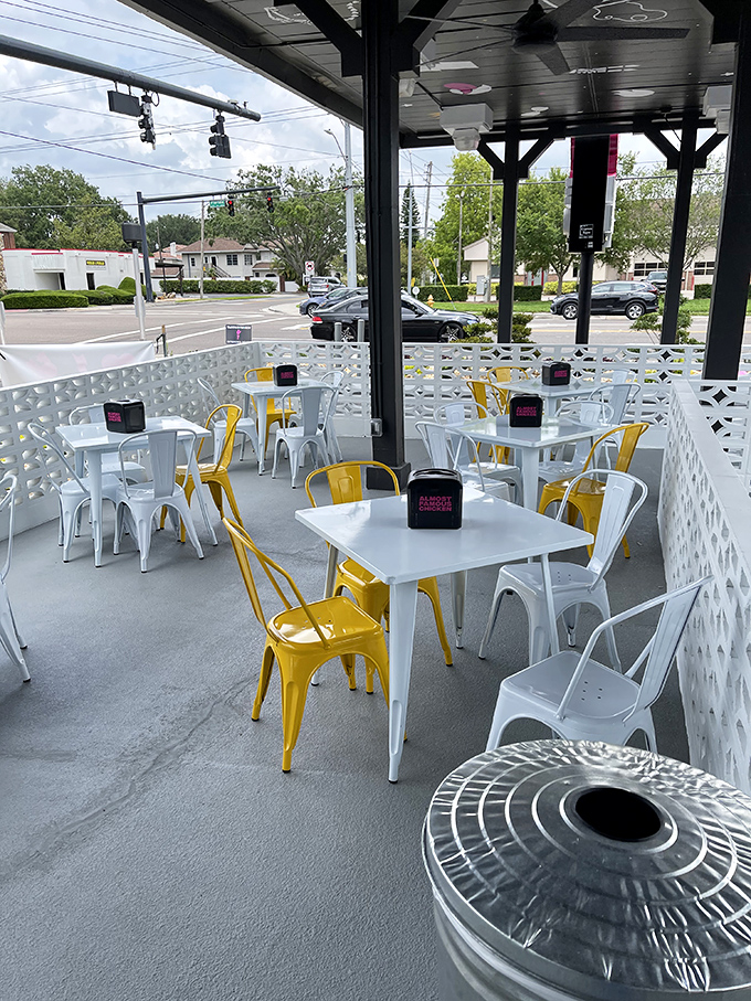 The outdoor patio offers a moment of post-chicken contemplation, with cheerful yellow chairs that match your elevated mood.