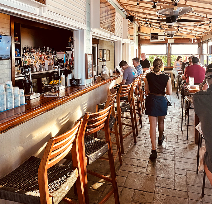 Sunlight dances across the patio bar, where ocean breezes enhance every sip and conversation flows as freely as the cocktails.